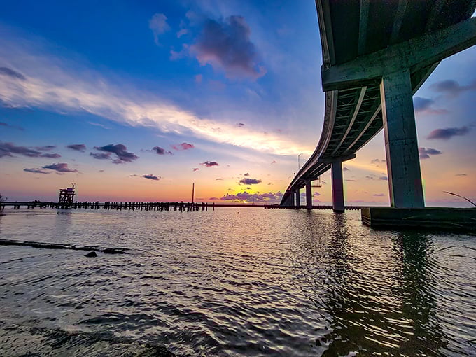 As the sun sets behind the bridge, Apalachicola Bay transforms into a watercolor masterpiece that no filter could possibly improve.