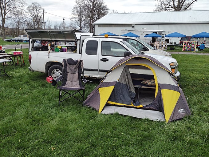 The dedicated vendor's temporary home—complete with tent and folding chair—proves that at Tiffin, the early bird not only gets the worm but also the prime selling spot.