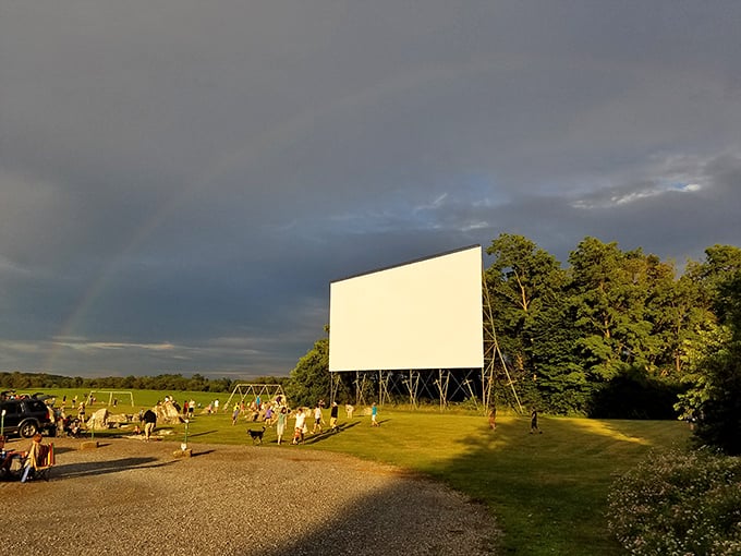 Sometimes Mother Nature adds her own special effects—a rainbow arching over the screen suggests you've definitely picked the right evening for outdoor cinema.