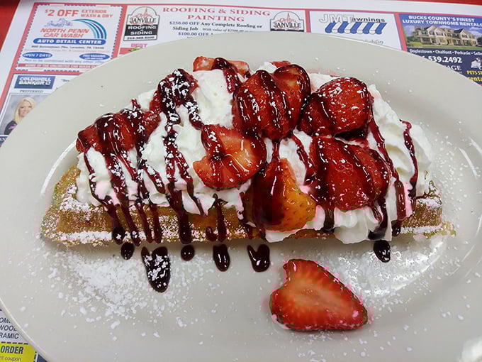 This isn't just a waffle—it's a platform for berry brilliance, whipped cream clouds, and syrupy dreams. Breakfast or dessert? Yes.