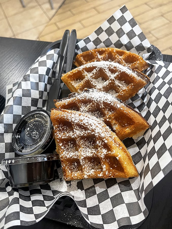 Waffles dusted with powdered sugar – the dessert you didn't know you needed after a Nashville hot chicken experience.