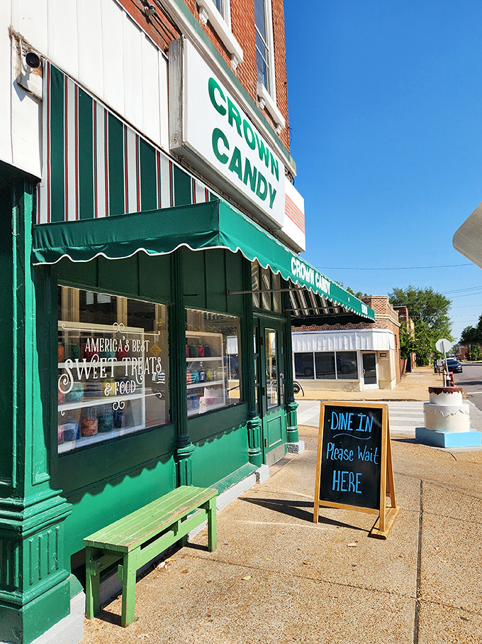 The green awning and "Please Wait Here" sign—the final barrier between you and a meal that will ruin lesser sandwiches for you forever.
