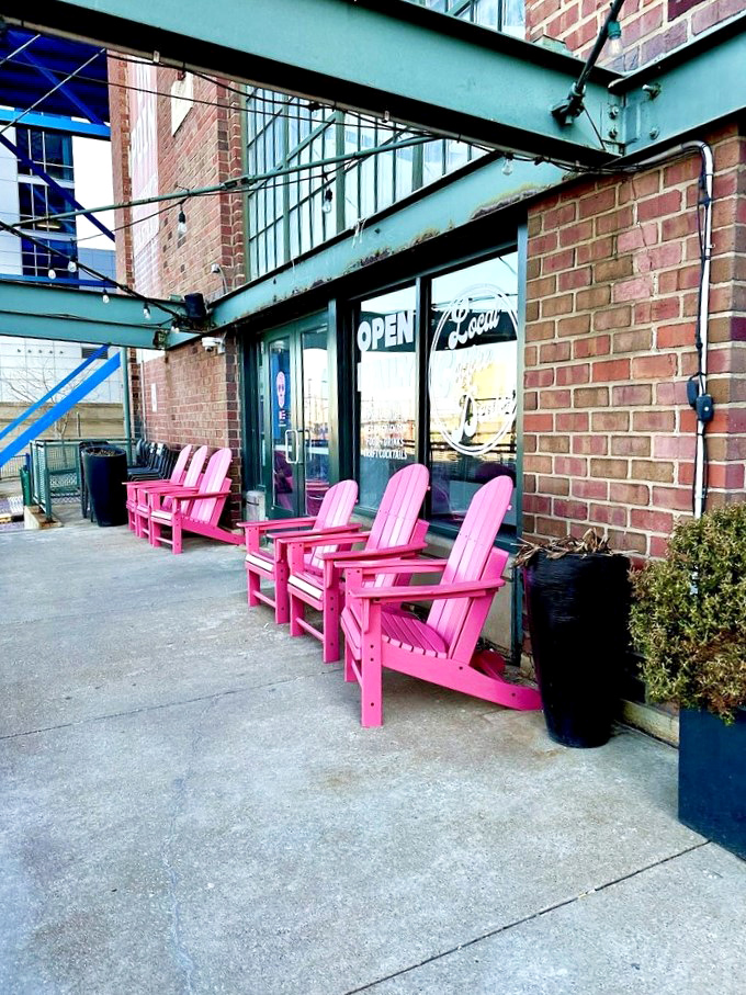 Those pink chairs aren't just furniture—they're Cleveland's most cheerful welcome committee, standing guard outside this brick-fronted coffee haven.