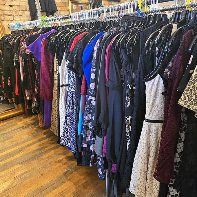 The dress selection ranges from everyday wearable to "starring in your own personal music video"—all hanging on racks against exposed brick that screams authentic character.