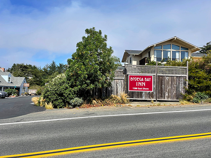 Weathered inn signs and coastal fog create the authentic Northern California fishing village experience.