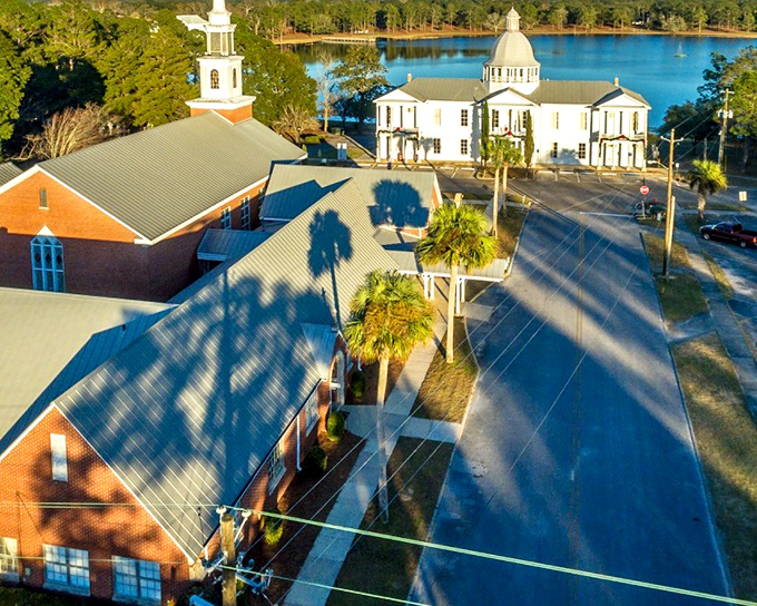 DeFuniak Springs' Victorian houses gather around that perfectly round lake like elegant guests at a garden party.