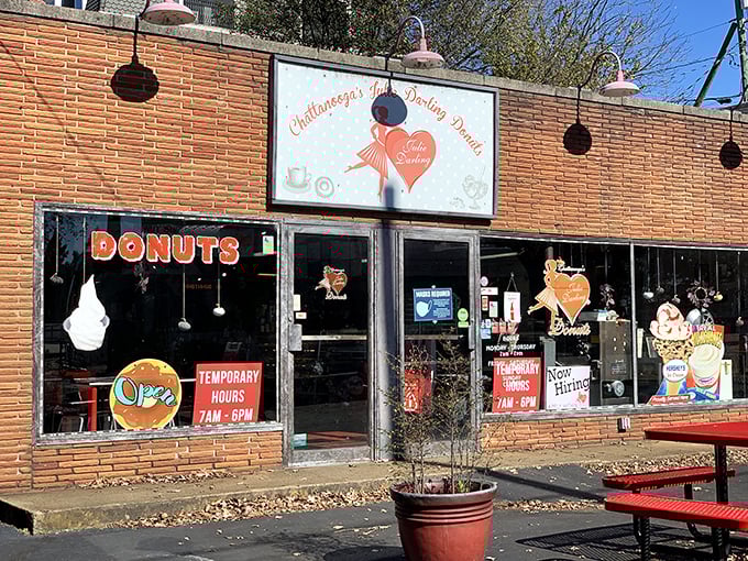Julie Darling's brick storefront beckons with that classic neon DONUTS sign – like a lighthouse for your sweet tooth!