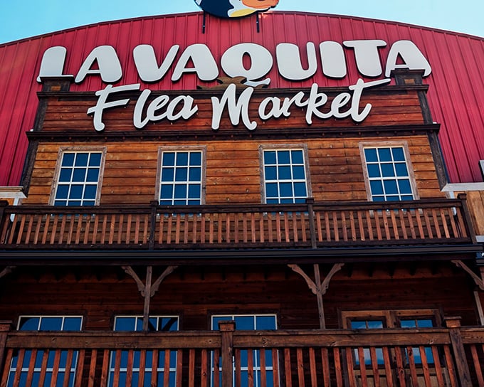 The grand wooden facade of La Vaquita Flea Market beckons like a Wild West trading post with a Latin twist.