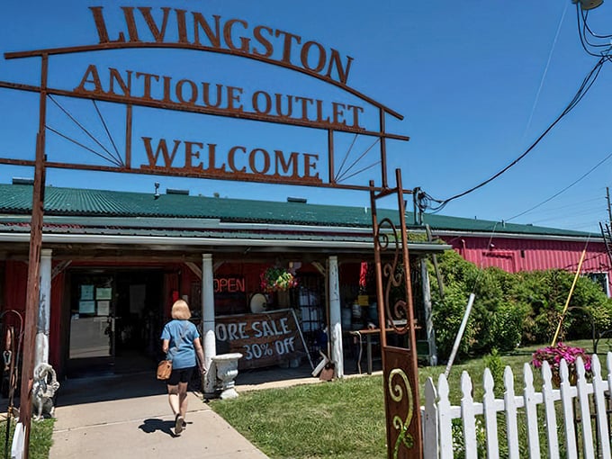 The rusty welcome sign at Livingston Antique Outlet promises treasures inside – like a time portal disguised as a country store.
