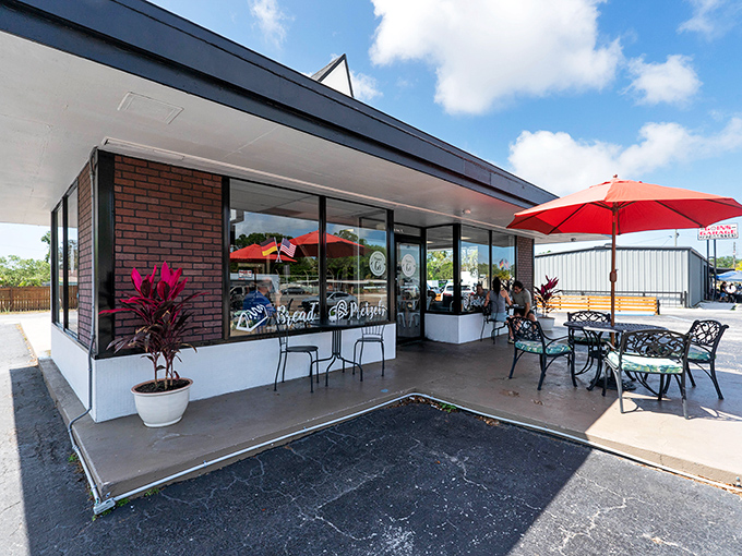 Modern meets cozy at this Kenneth City gem where red umbrellas promise shade and sweet surprises await inside.