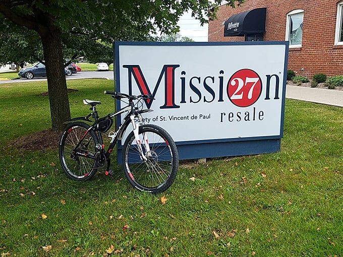 The iconic Mission 27 Resale sign stands proudly outside their brick building. That bicycle looks ready for its second adventure!