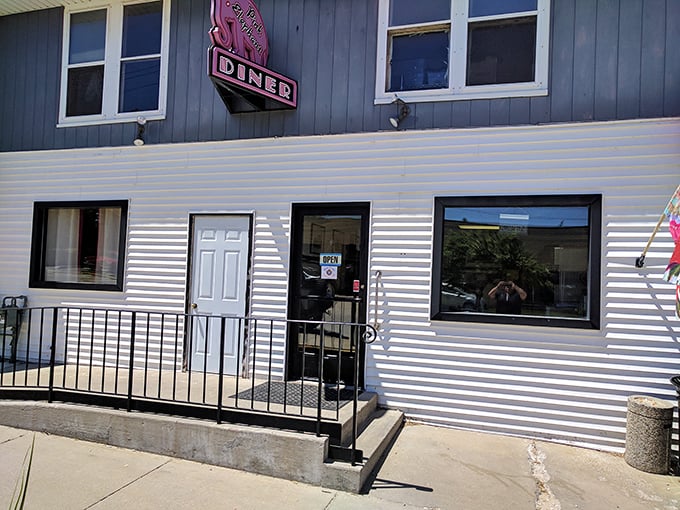 The Pink Elephant Diner's classic striped exterior promises comfort food that'll make your taste buds do a happy dance.