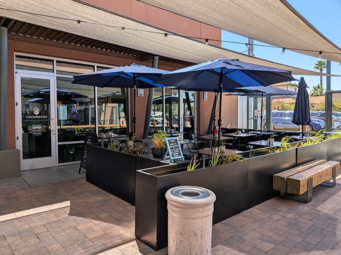 Vovomeena's inviting patio beckons with navy umbrellas standing guard against Arizona's enthusiastic sunshine, promising a breakfast experience worth writing home about.