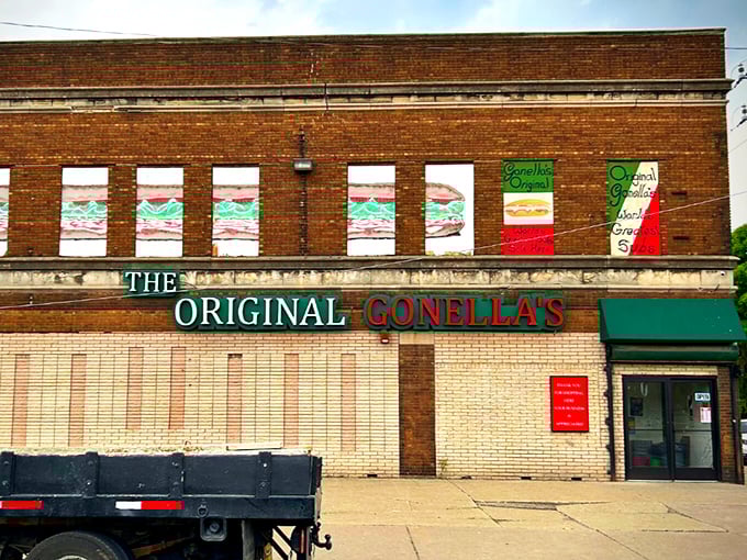 That iconic brick facade with sandwich murals tells you everything – legendary Italian subs await inside!