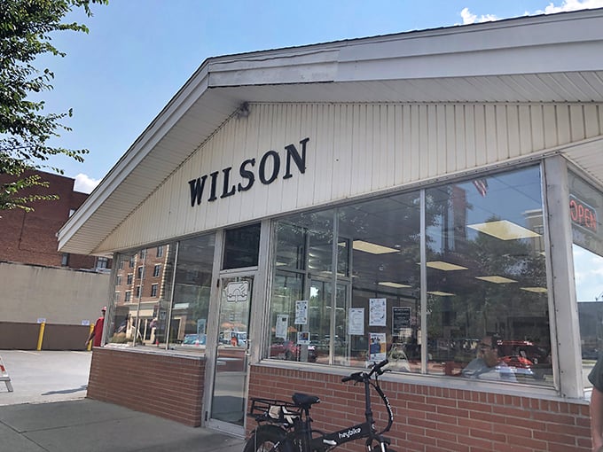 Wilson's iconic storefront stands as a time capsule of American diner culture, promising simple pleasures done perfectly.