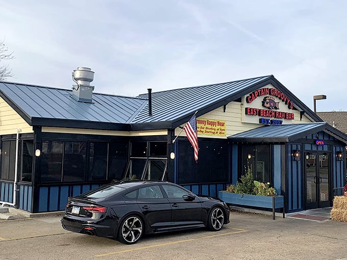 The American flag flutters proudly outside this unassuming seafood haven, where "Groovy Happy Hour" isn't just a sign—it's a way of life.