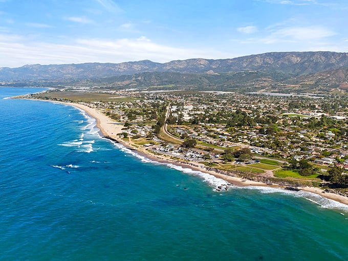 Mountain backdrops frame this peaceful coastal haven where surfers and sunbathers share miles of pristine, family-friendly shoreline.