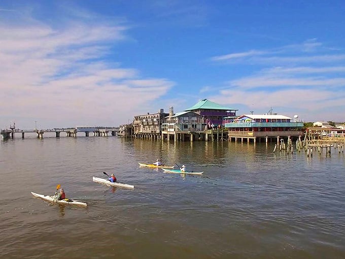 Paddle your way to paradise! These kayakers are heading toward Cedar Key's stilted treasures—like rowing into a Jimmy Buffett song come to life.