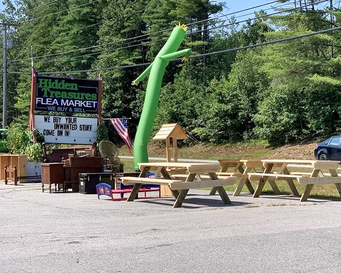 That waving green inflatable tube man isn't just saying hello—he's signaling that bargain treasures await inside this Swanzey gem.