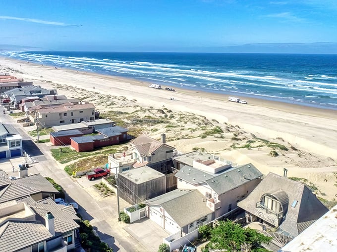 Beach houses dot the dunes like colorful confetti celebrating California's coastal charm and affordable dreams.