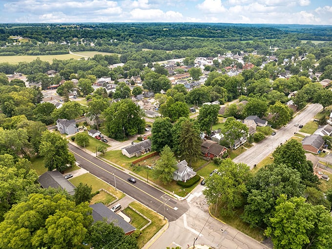 American flags flutter along Waynesville's charming streetscape, where colorful storefronts invite you to slow down and remember what shopping was like before Amazon.