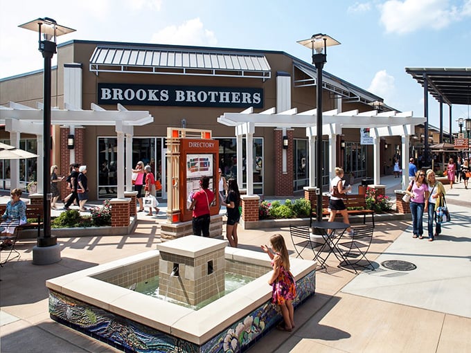 Brooks Brothers anchors the premium experience with classic American style. That little fountain isn't just pretty—it's where shopping companions recharge their patience.