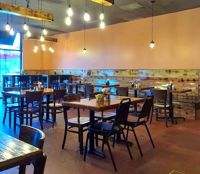 Edison bulbs cast a warm glow over rustic wood paneling, creating that perfect "fancy but not too fancy" vibe where both bedhead and business casual feel equally at home.
