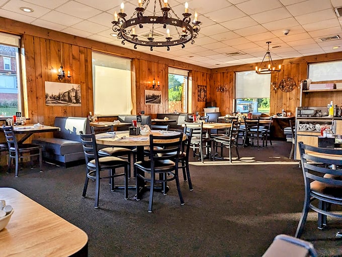 Warm wood paneling and wrought iron chandeliers create the perfect backdrop for morning conversations. Comfort begins before the food arrives.