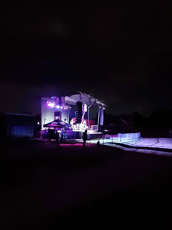 As twilight fades, the massive screen comes alive with a performer, turning ordinary vehicles into front-row seats to extraordinary entertainment.