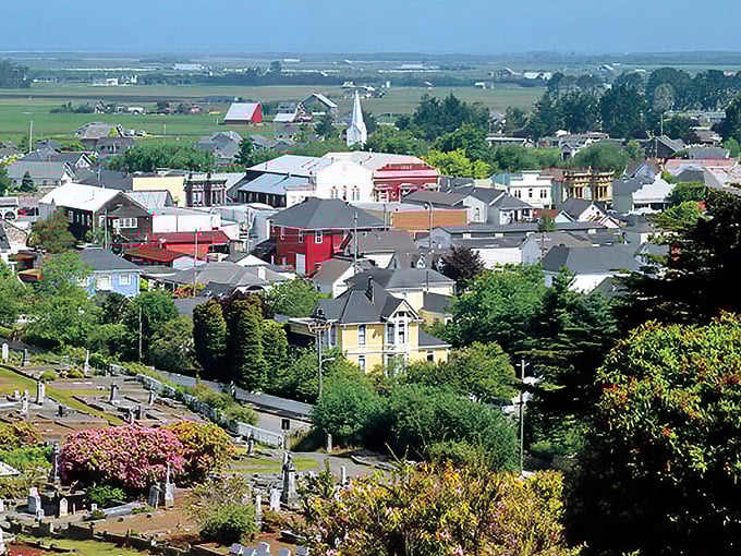 From above, Ferndale reveals its storybook quality—colorful Victorian homes nestled between rolling farmland and forested hills, with the iconic white church spire standing sentinel.