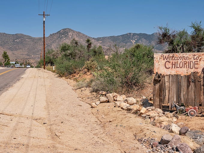 This weathered "Welcome to Chloride" sign has greeted visitors for decades – a rustic handshake from a town that refuses to surrender to time.
