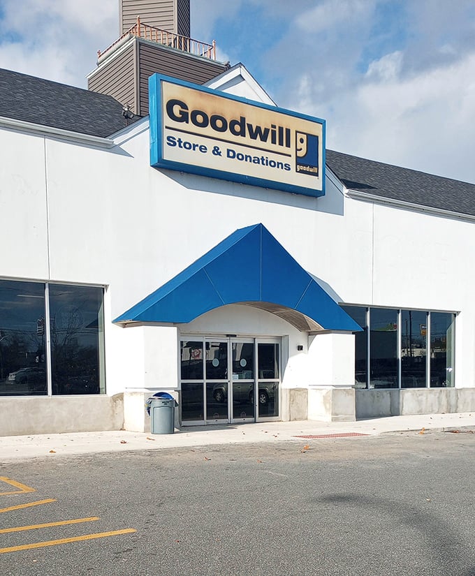 The iconic blue awning and Goodwill sign welcome bargain hunters and treasure seekers alike. Your adventure begins with these sliding doors.