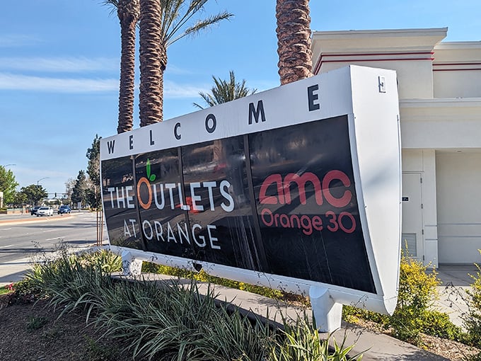 The welcoming sign promises not just shopping but an experience—AMC theaters for when your credit card needs a timeout.