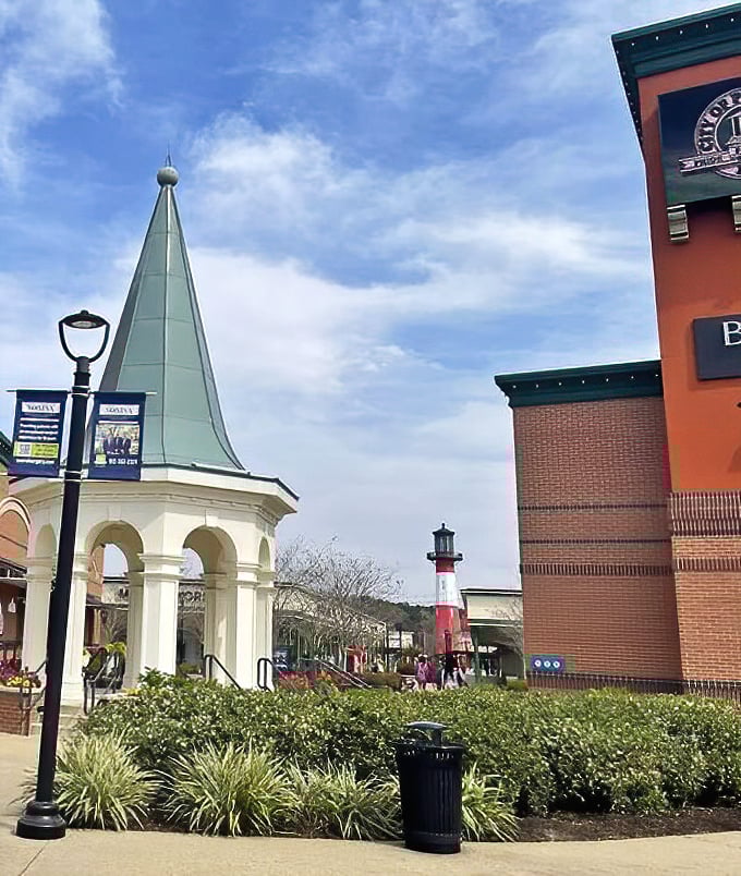 This architectural gem blends Southern charm with shopping paradise – note the spired gazebo and lighthouse beckoning bargain hunters like retail sirens.