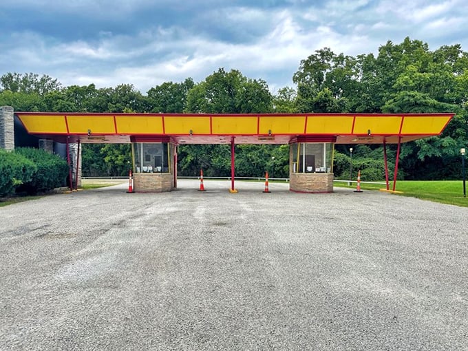 The iconic yellow and red entrance booths stand like cheerful sentinels, welcoming movie lovers to their nostalgic escape.