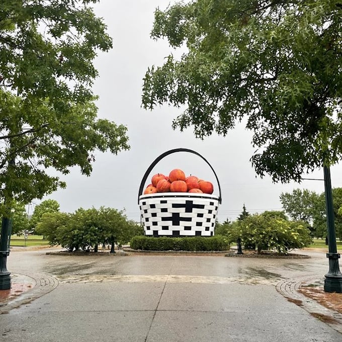 Rain-slicked pathways lead visitors to this colossal creation, where the humble picnic basket gets its moment in the spotlight.