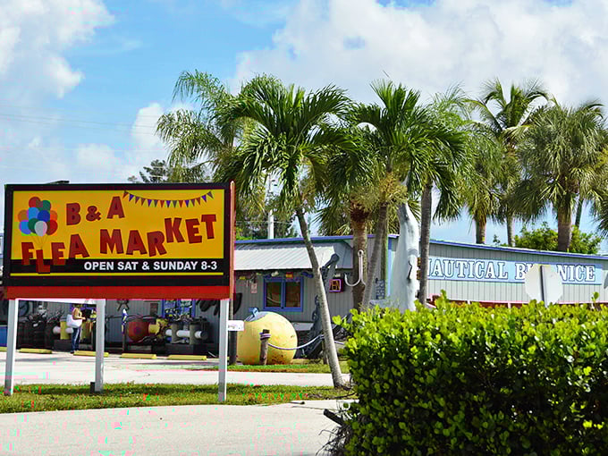 Florida sunshine and palm trees frame the vibrant B&A Flea Market sign, a beacon for weekend warriors seeking bargains beneath those swaying fronds.