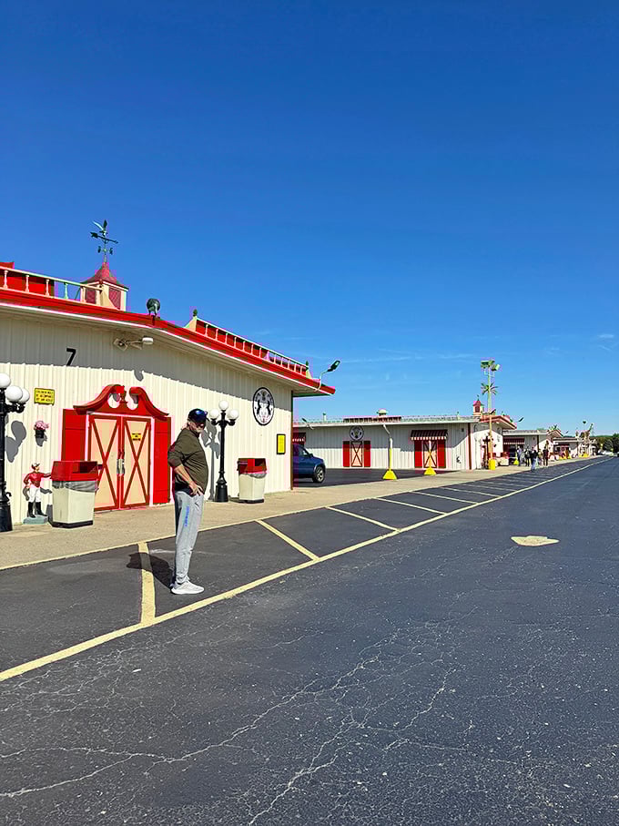 A shopper contemplates his next move outside Building 7, where the distinctive red trim and weathervane hint at the treasures housed within these market halls.