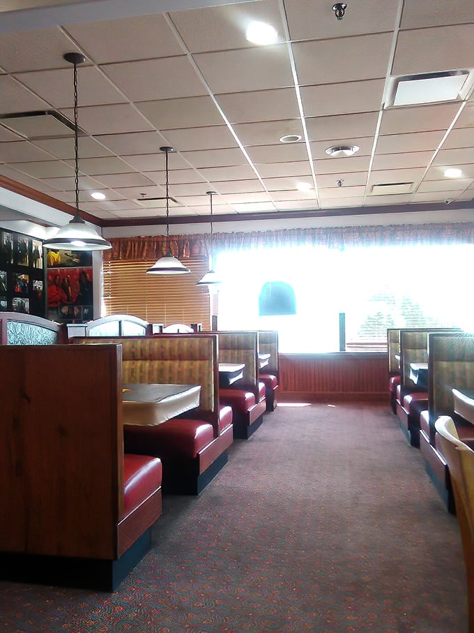 Classic red booth seating awaits inside, perfectly designed for the serious business of rib enjoyment and sauce-induced food comas.