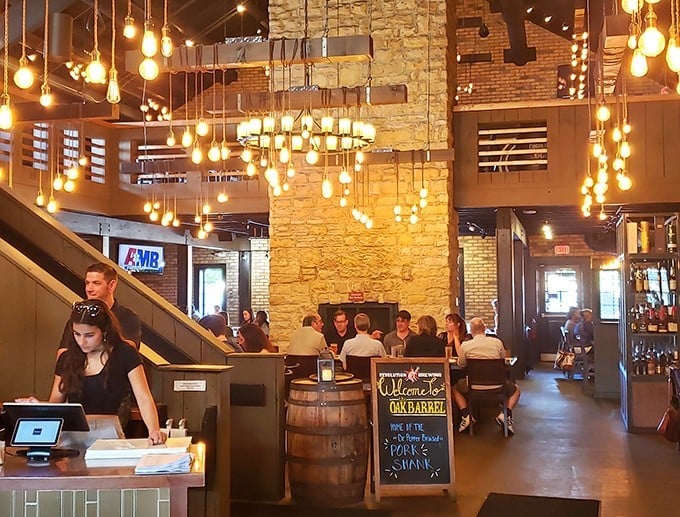 Edison bulbs dance overhead like fireflies in a stone and wood cathedral dedicated to the worship of good food and better company.