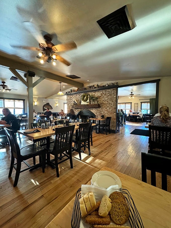 Step inside to discover what heaven's dining room might look like—warm wood, stone fireplace, and the promise of prime rib perfection.