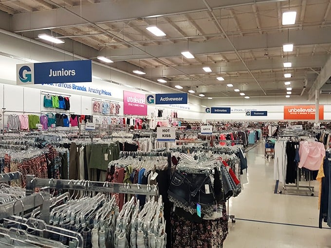 Endless racks of discounted treasures await inside, where savvy shoppers navigate a sea of fashion finds organized by helpful overhead signage.