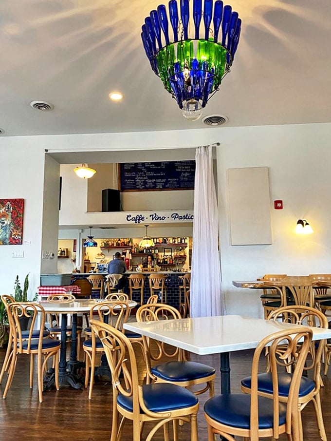 That blue and green bottle chandelier isn't just lighting the room – it's setting the mood for the Italian escape that awaits beneath its glow.