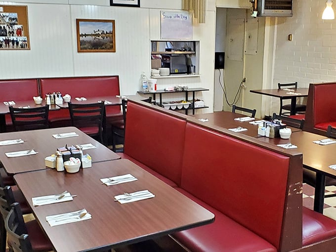Classic red vinyl booths and simple tables create that perfect nostalgic diner atmosphere where comfort food memories are made daily.