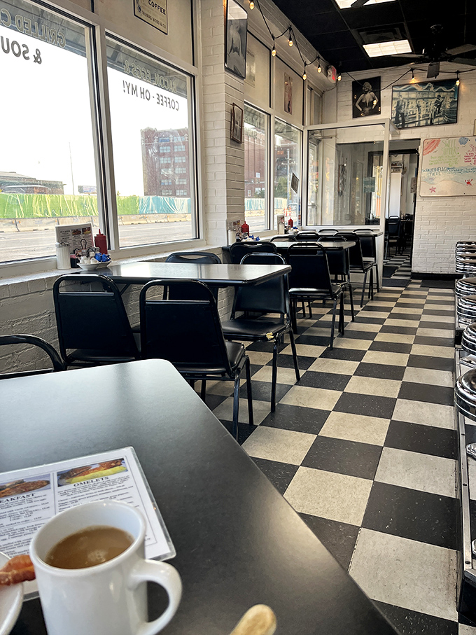 Morning light streams through windows onto that iconic checkerboard floor—the universal signal that you're about to experience breakfast done right.