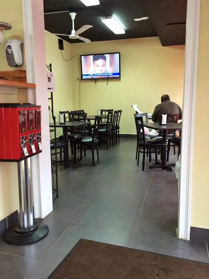 Simple yellow walls and black tables create the perfect backdrop for the star of the show—that legendary pan pizza.