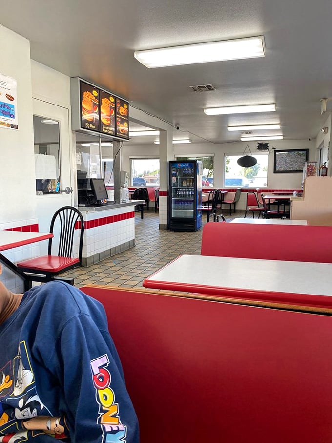 Classic red vinyl booths and checkerboard floors create the quintessential diner experience—where conversations flow as freely as the fountain drinks.