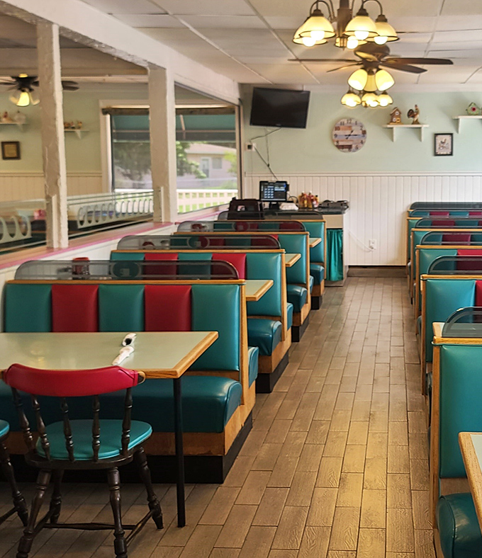 Classic diner booths in teal and red vinyl invite you to slide in and stay awhile. This isn't Instagram-bait decor—it's the real deal comfort zone.