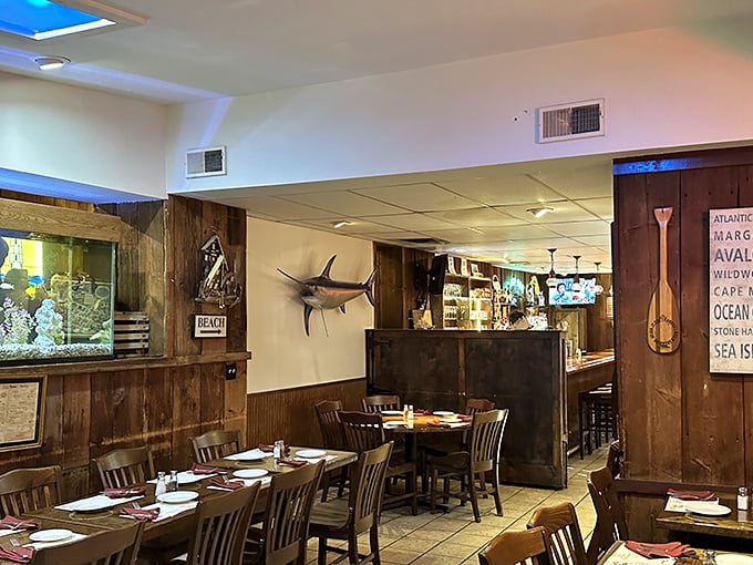 Inside, nautical charm abounds with wood-paneled walls, mounted fish, and an aquarium—like stepping into a cozy New England fishing village.