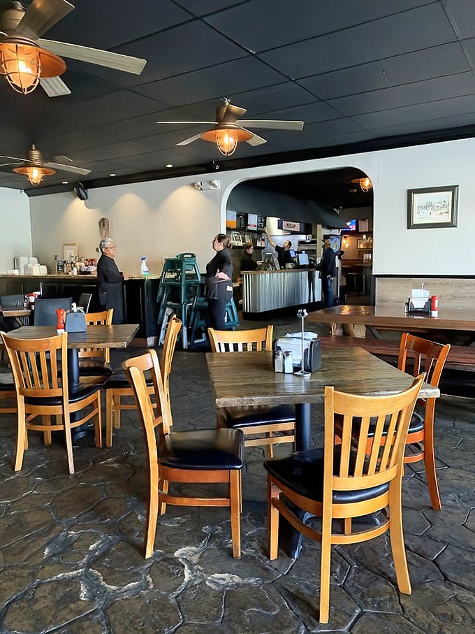Wooden tables, stone floors, and industrial lighting create the perfect backdrop for serious barbecue business. No distractions, just meat meditation.